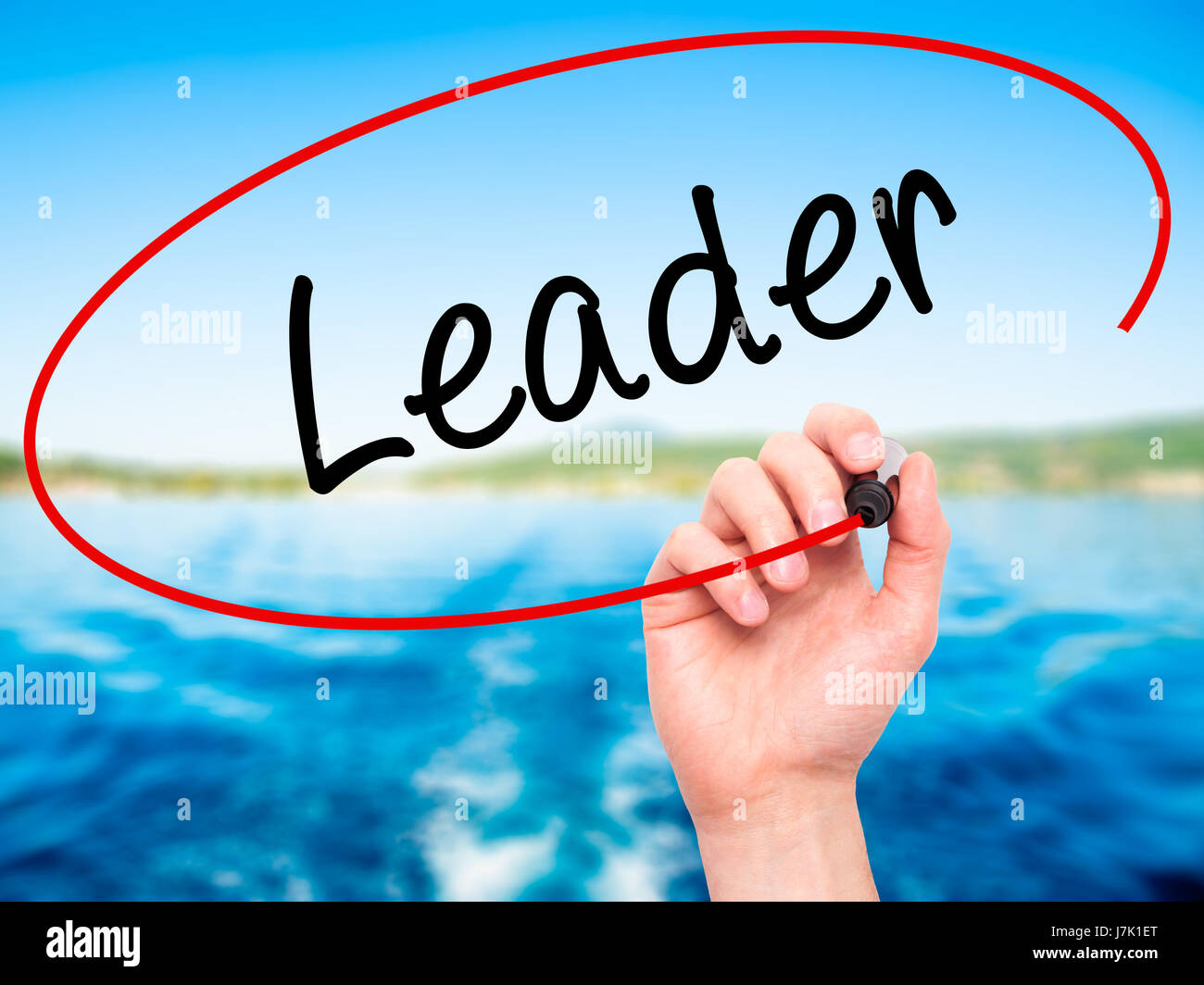 Man Hand writing Leader with black marker on visual screen. Isolated on ...