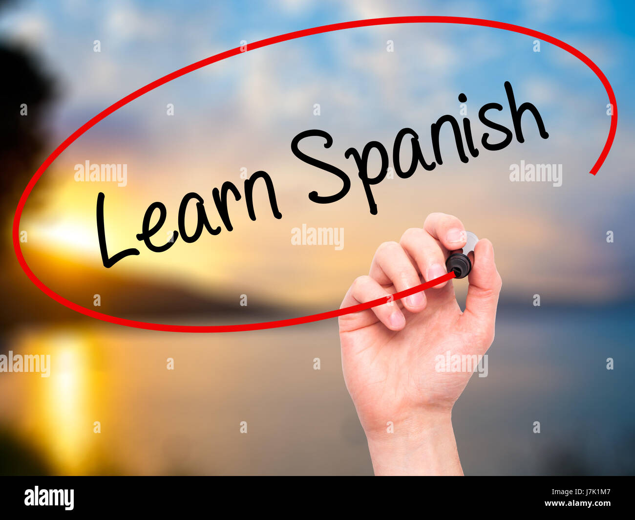 Man Hand writing Learn Spanish with black marker on visual screen ...