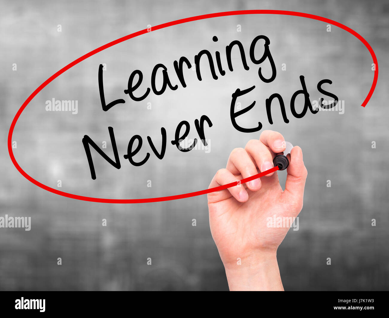 Man Hand writing Learning Never Ends with black marker on visual screen ...