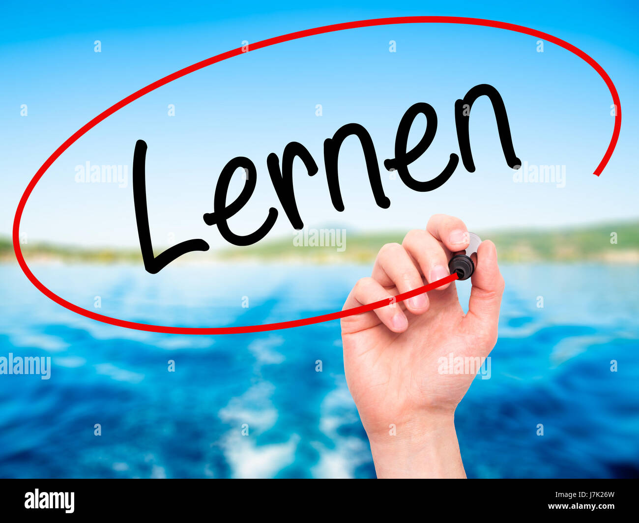 Man Hand writing Lernen (Learn in German) with black marker on visual ...