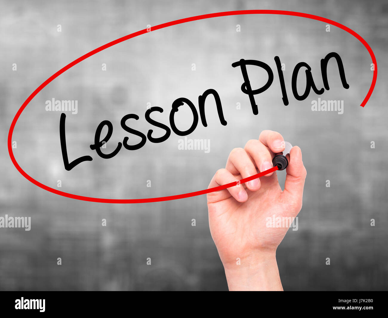 Man Hand writing Lesson Plan with black marker on visual screen ...