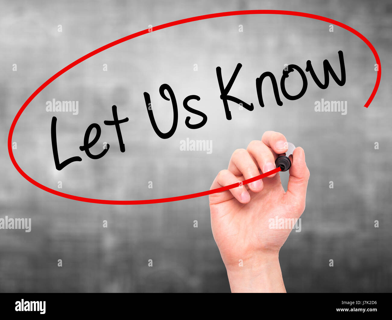 Man Hand writing Let Us Know with black marker on visual screen ...