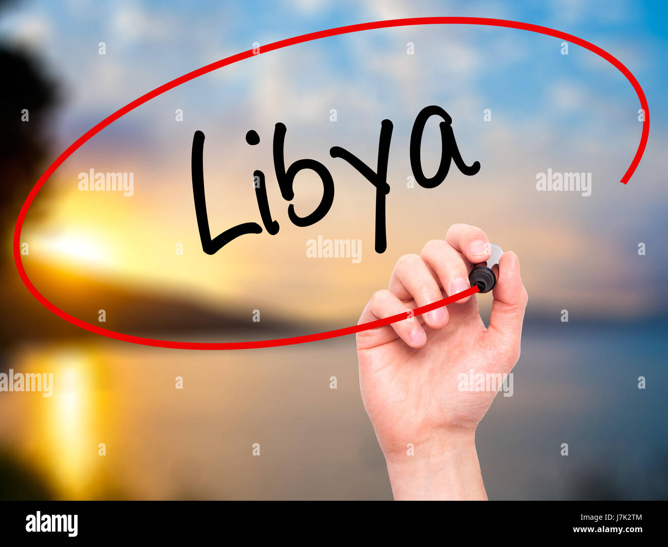 Man Hand writing Libya with black marker on visual screen. Isolated on ...