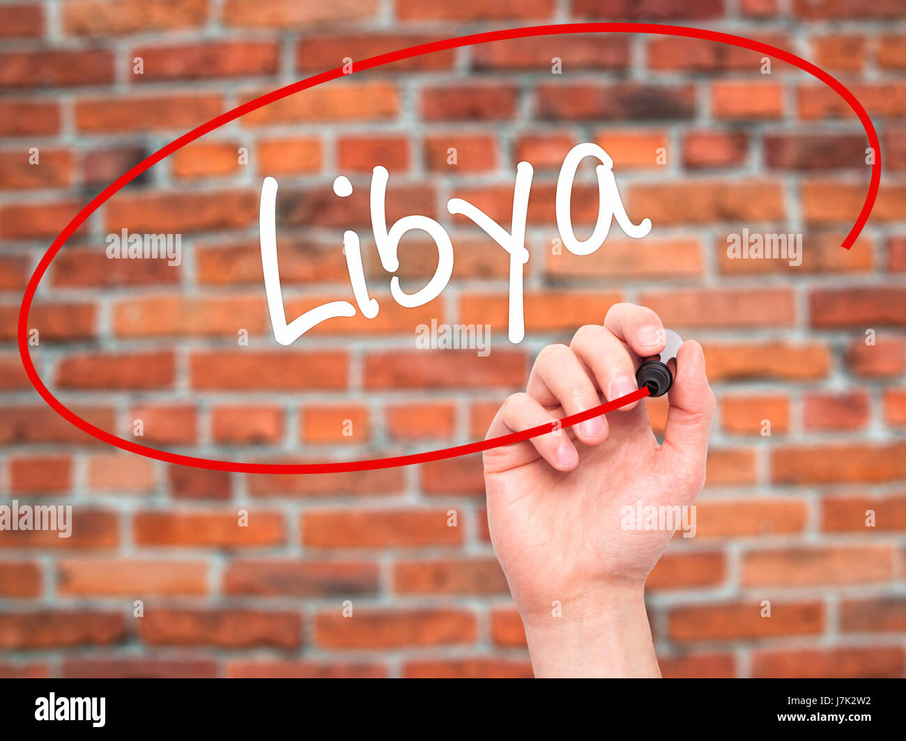 Man Hand writing Libya with black marker on visual screen. Isolated on ...
