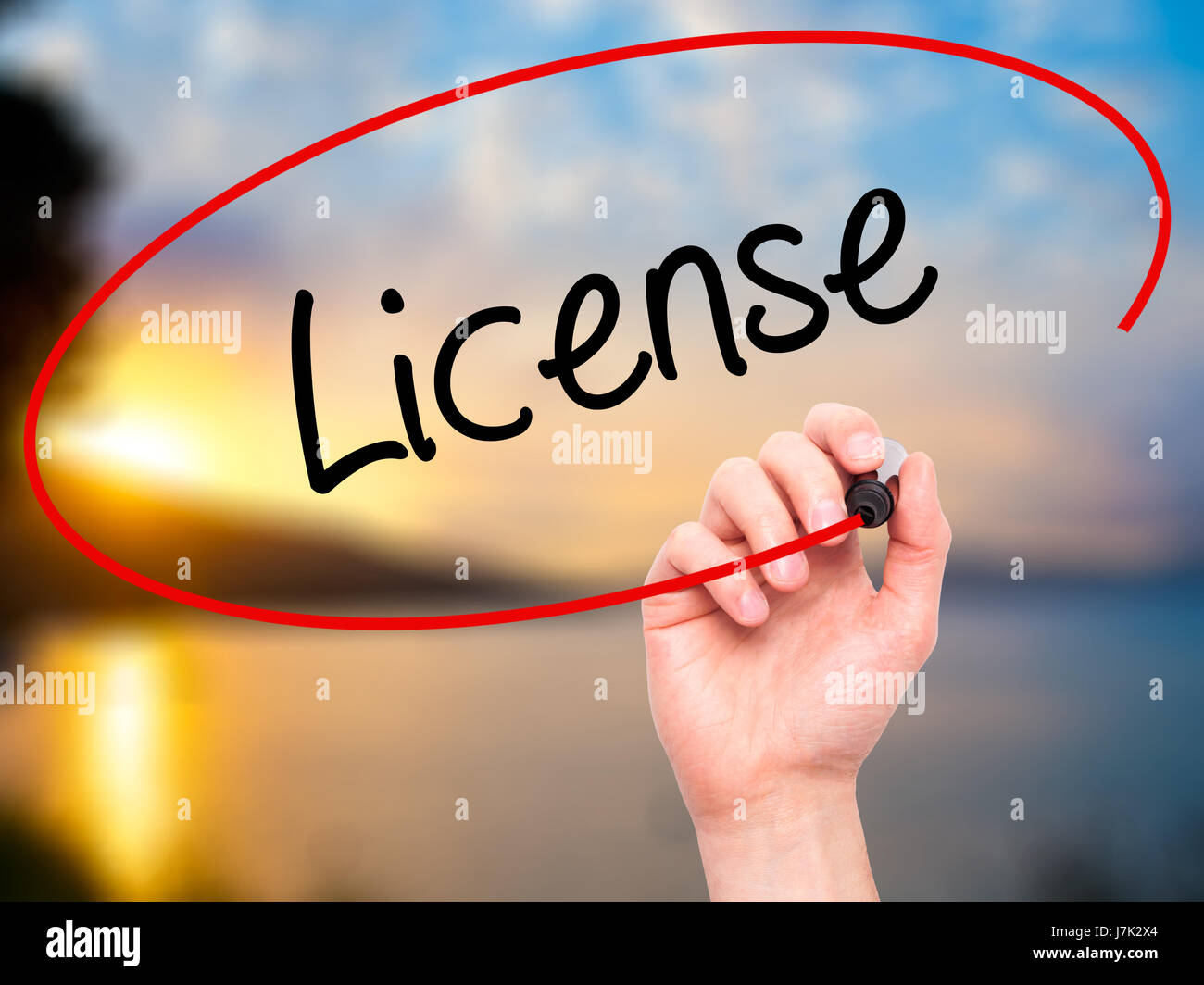 Man Hand writing License with black marker on visual screen. Isolated ...