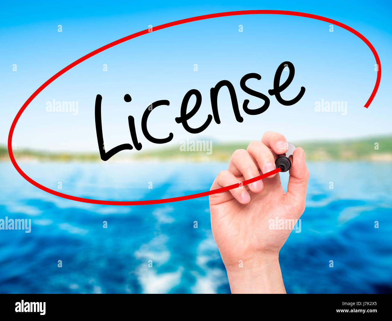 Man Hand writing License with black marker on visual screen. Isolated ...