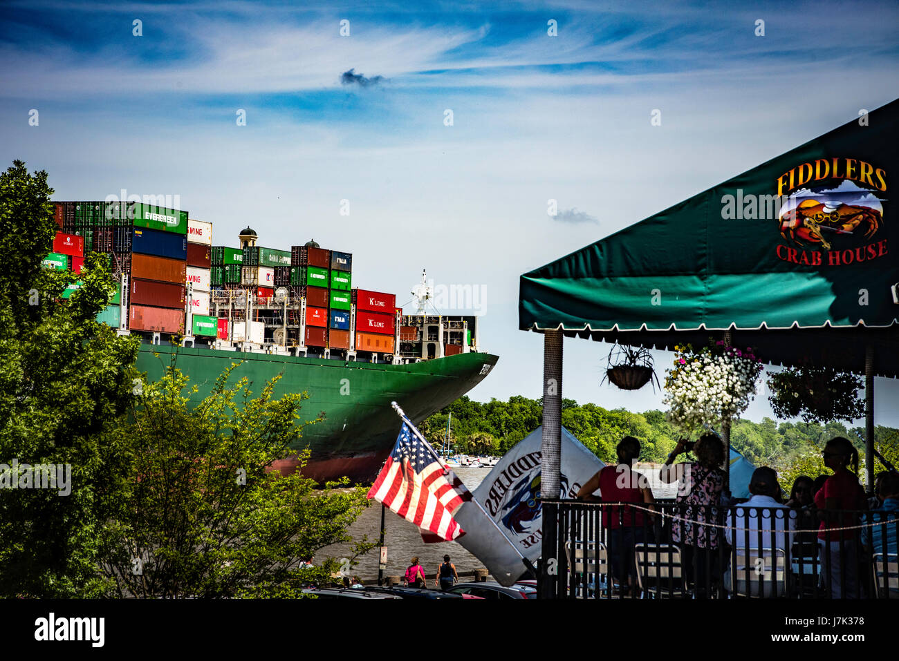 Ocean goin g freighter with cargo containers passes waterfront area of ...