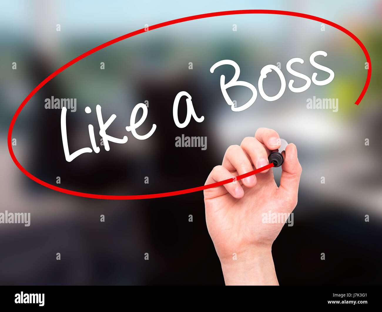 Man Hand writing Like a Boss with black marker on visual screen ...