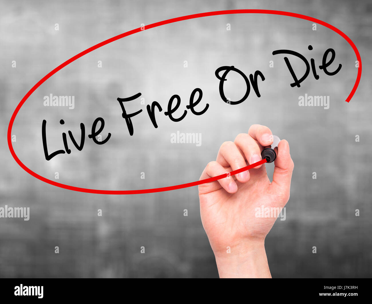 Man Hand writing Live Free Or Die with black marker on visual screen ...