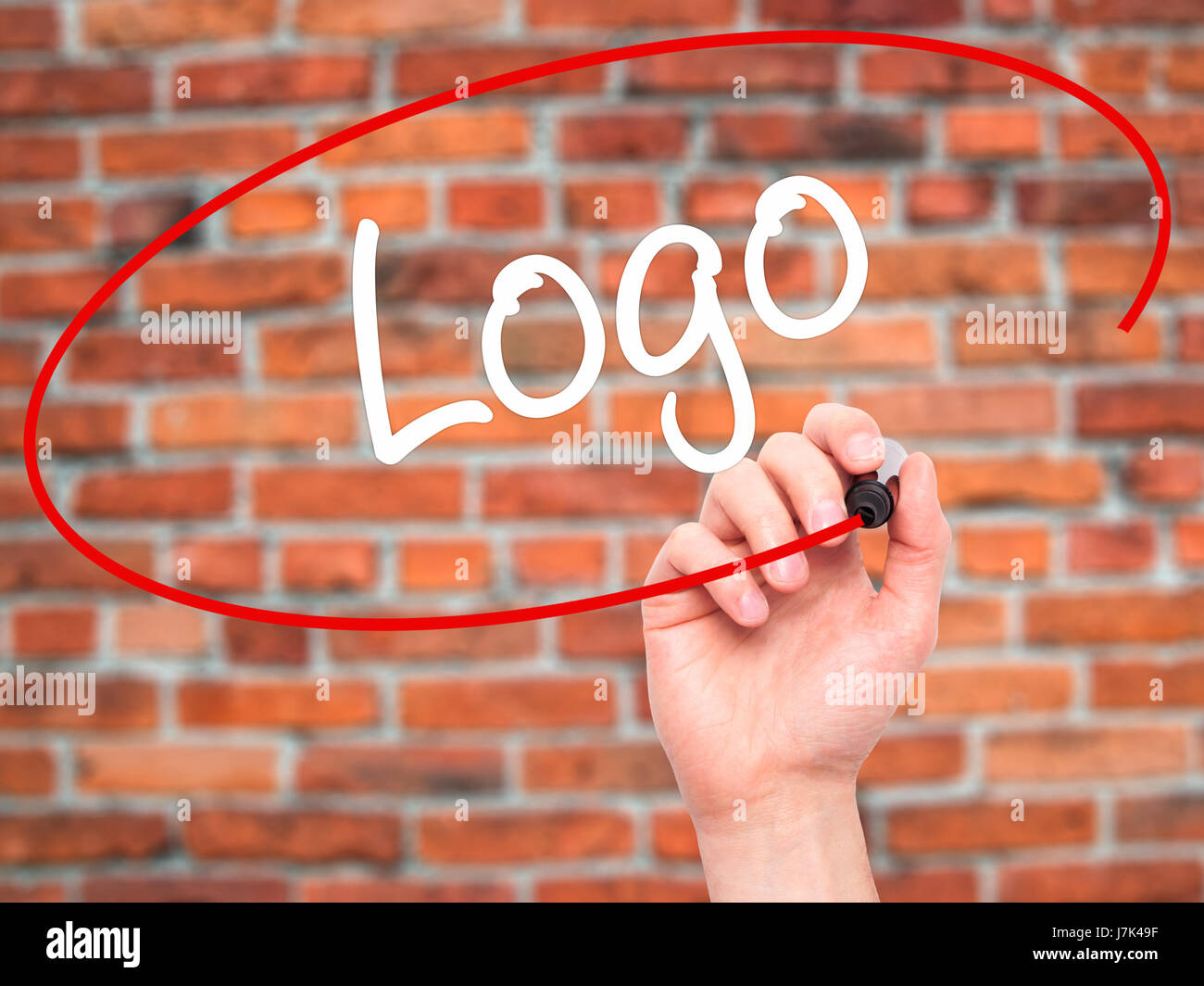 Man Hand writing Logo with black marker on visual screen. Isolated on ...