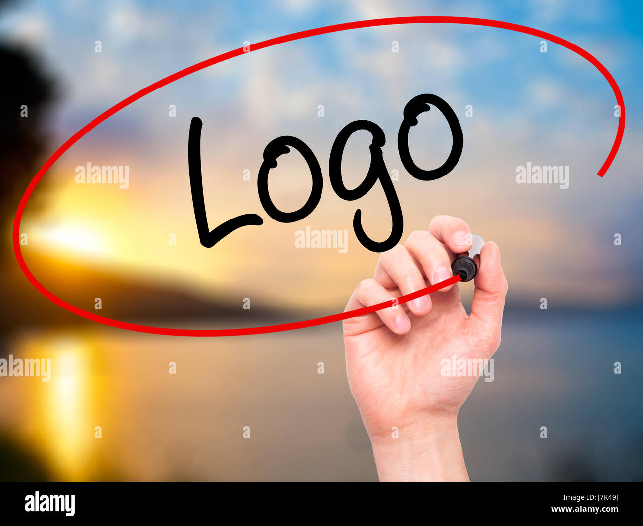 Man Hand writing Logo with black marker on visual screen. Isolated on ...