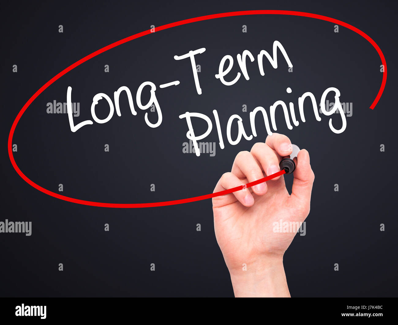 Man Hand writing Long-Term Planning with black marker on visual screen ...