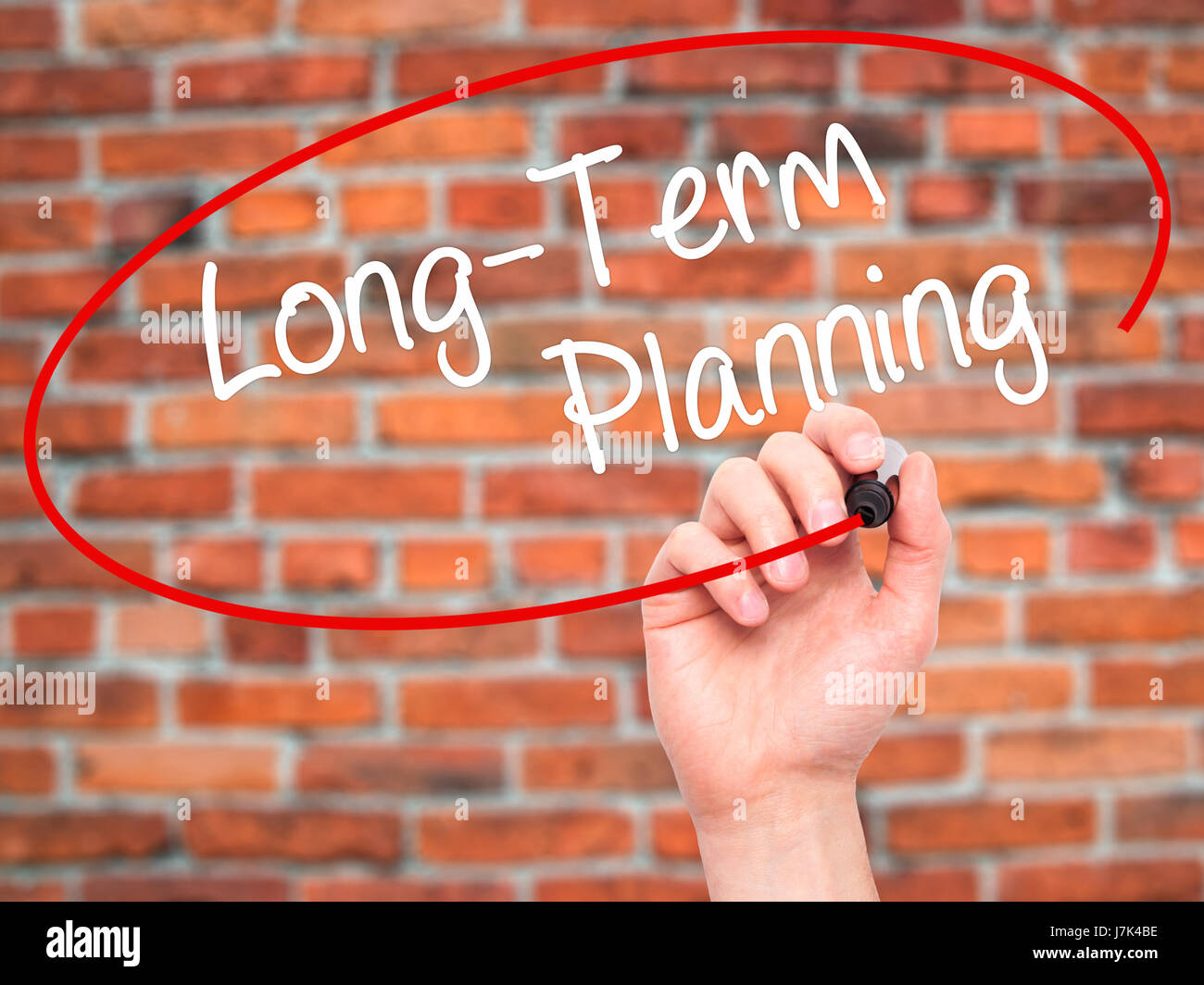 Man Hand writing Long-Term Planning with black marker on visual screen ...