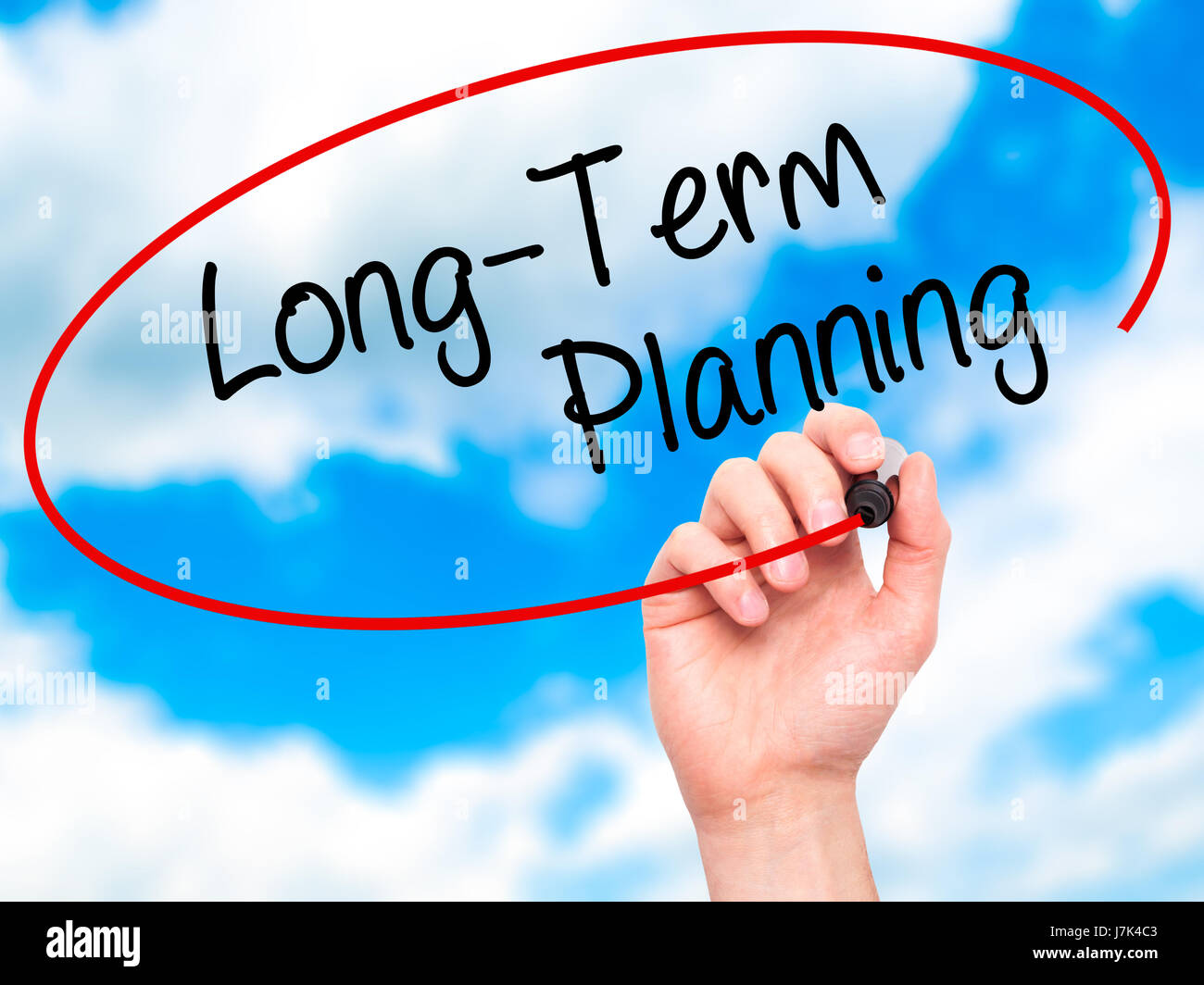 Man Hand writing Long-Term Planning with black marker on visual screen ...