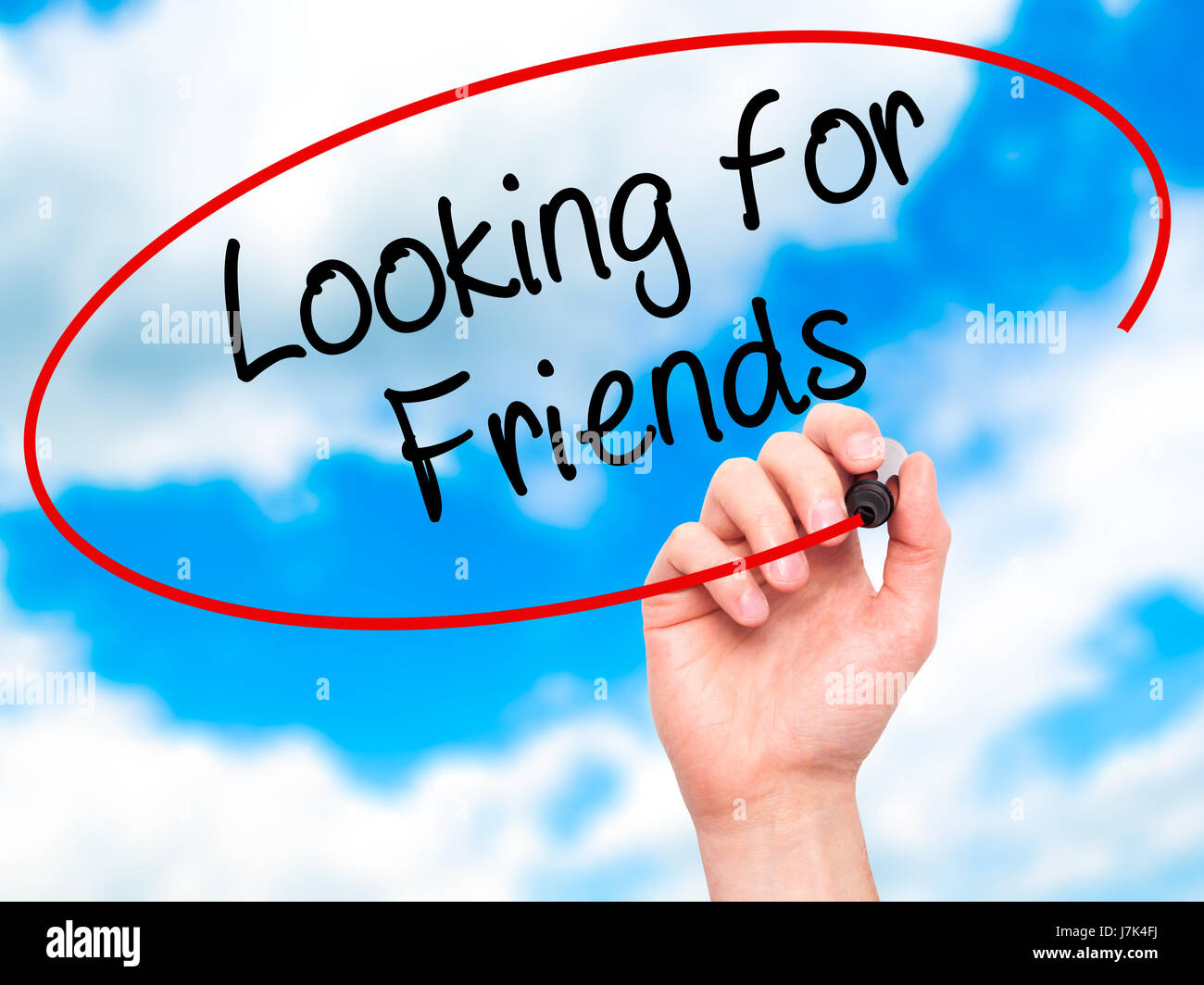 Man Hand writing Looking for Friends with black marker on visual screen ...