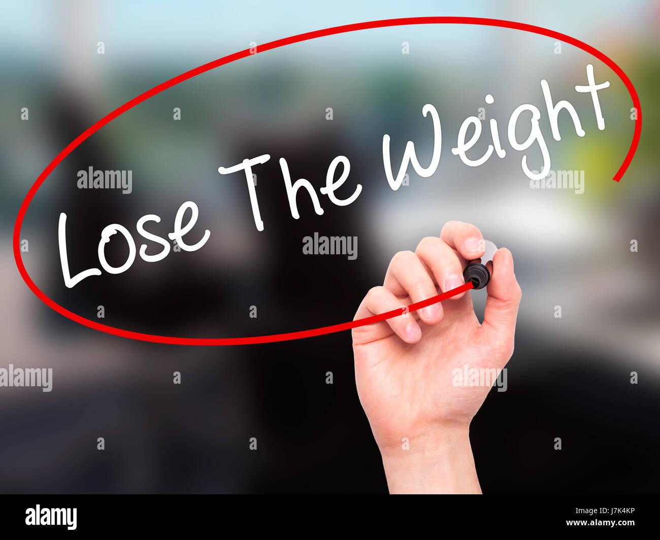 Man Hand writing Lose The Weight with black marker on visual screen ...