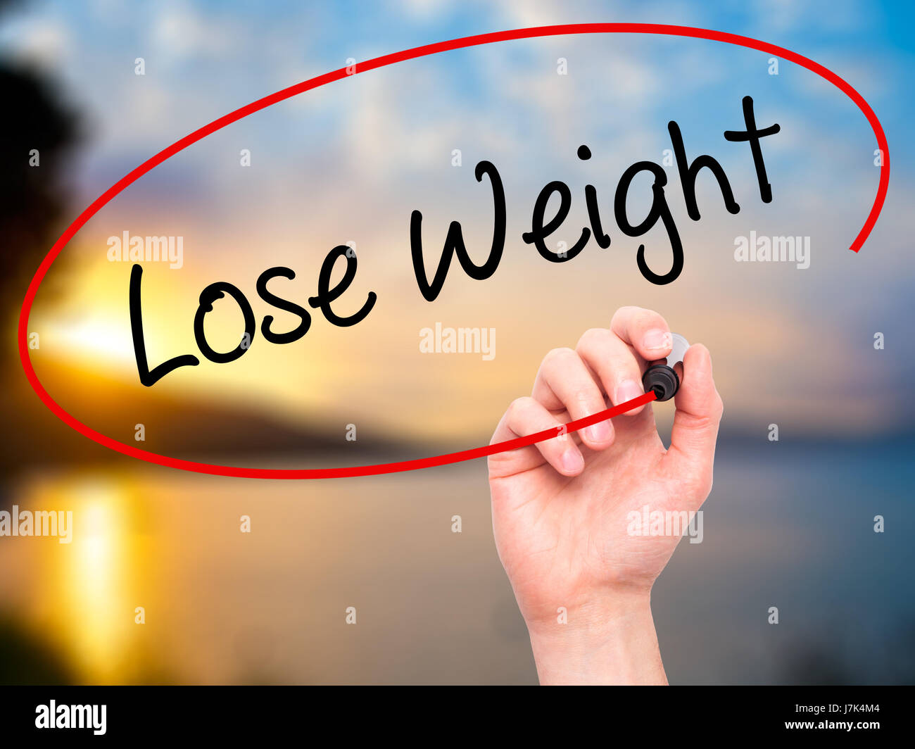 Man Hand writing Lose Weight with black marker on visual screen ...