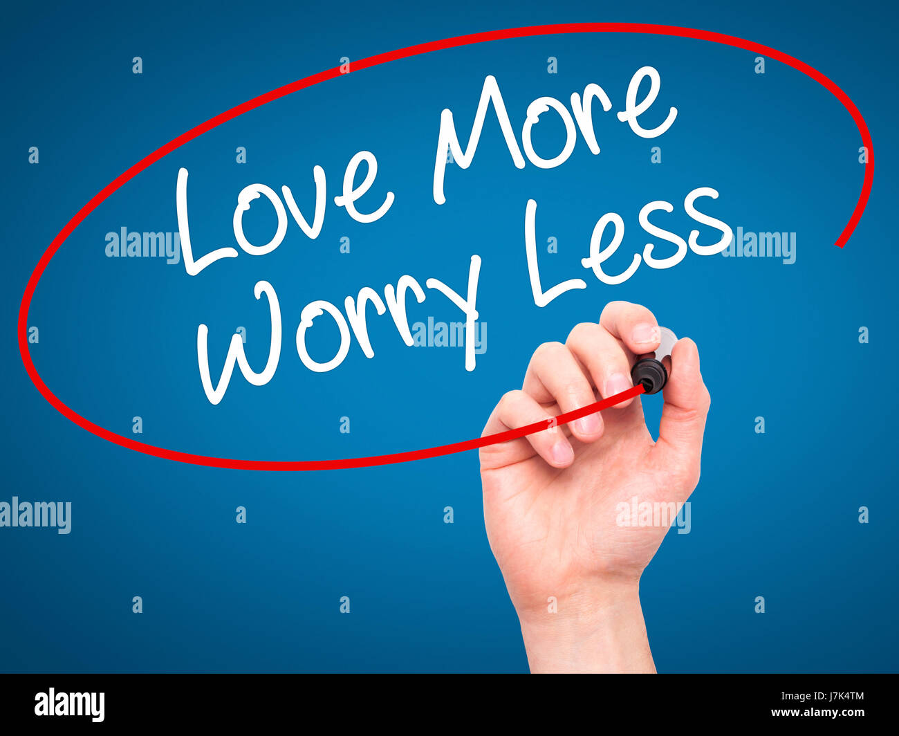 Man Hand writing Love More Worry Less with black marker on visual ...