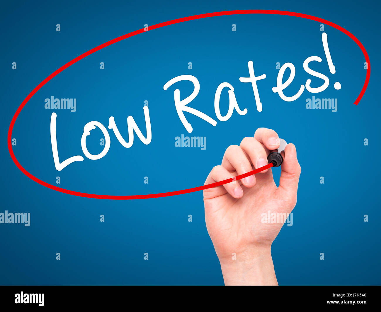Man Hand writing Low Rates! with black marker on visual screen ...