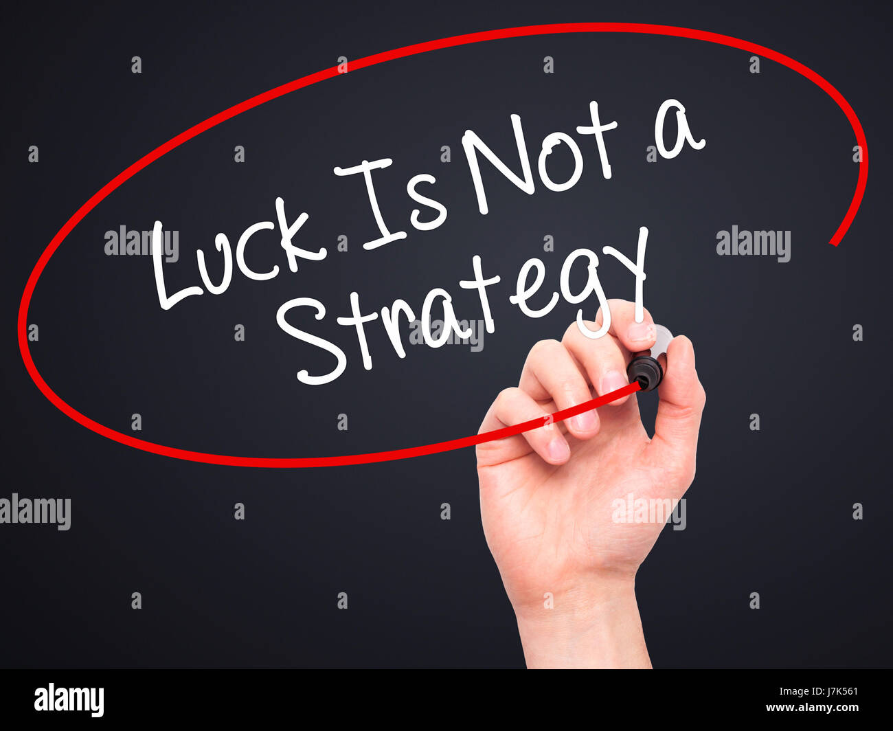 Man Hand writing Luck Is Not a Strategy with black marker on visual ...