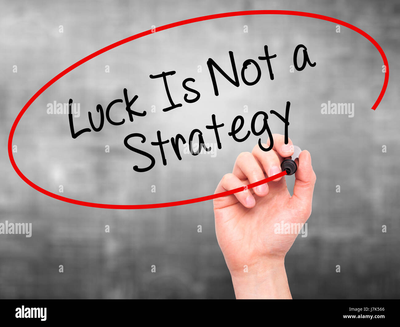 Man Hand writing Luck Is Not a Strategy with black marker on visual ...