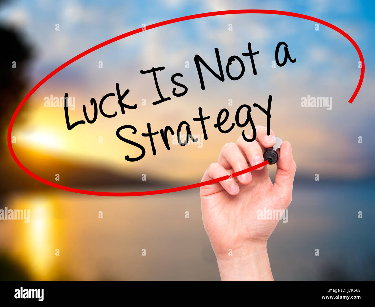 Man Hand writing Luck Is Not a Strategy with black marker on visual ...
