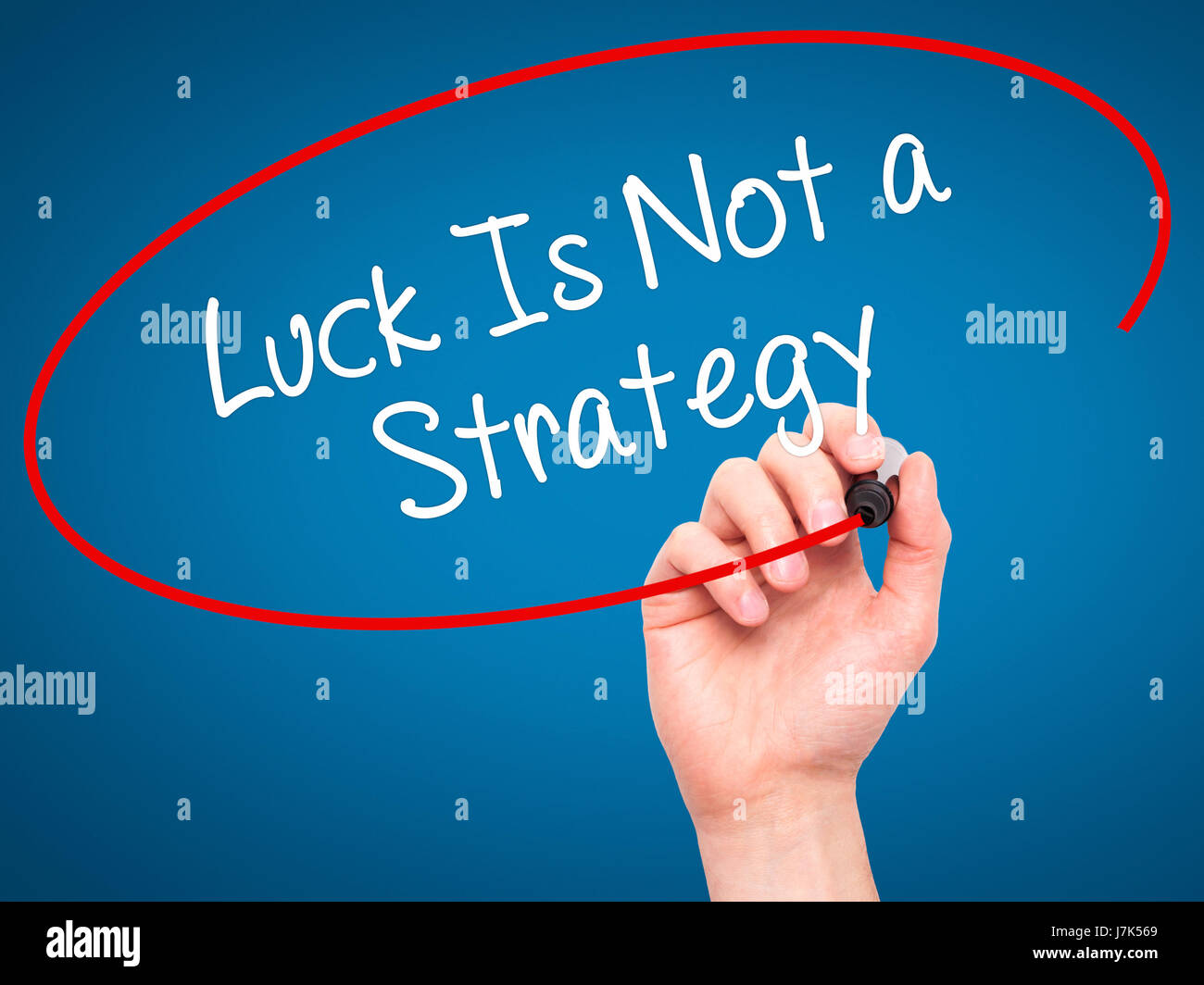 Man Hand writing Luck Is Not a Strategy with black marker on visual ...