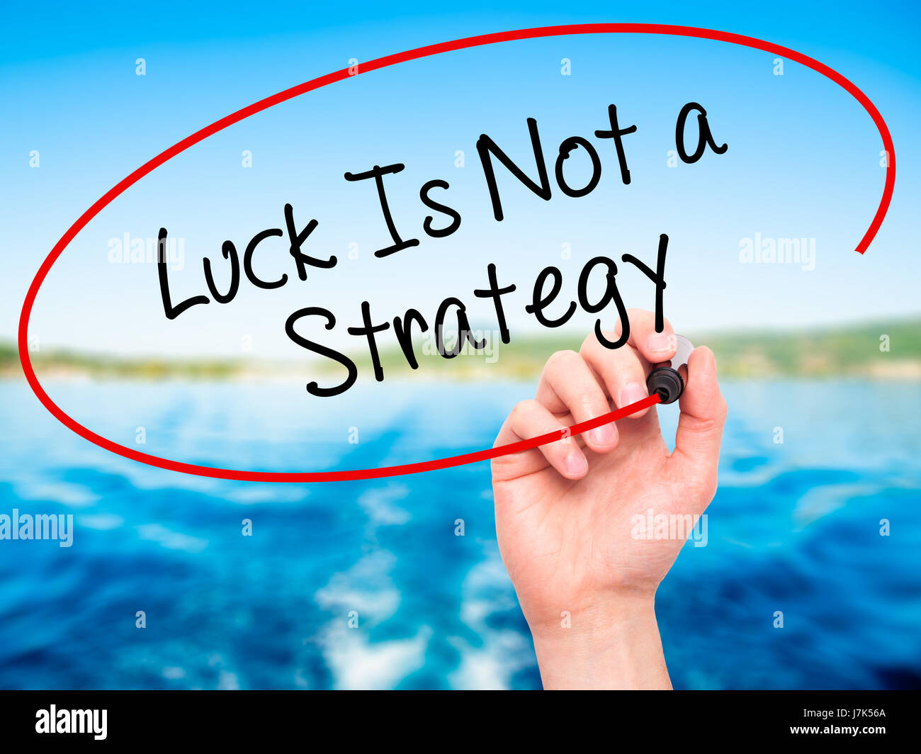 Man Hand writing Luck Is Not a Strategy with black marker on visual ...