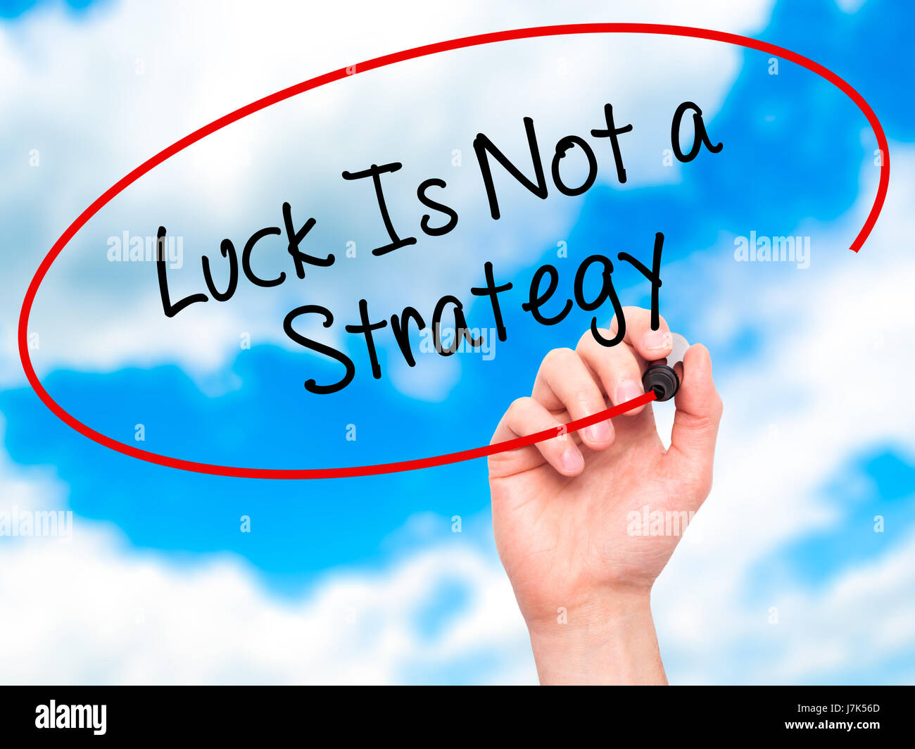 Man Hand writing Luck Is Not a Strategy with black marker on visual ...