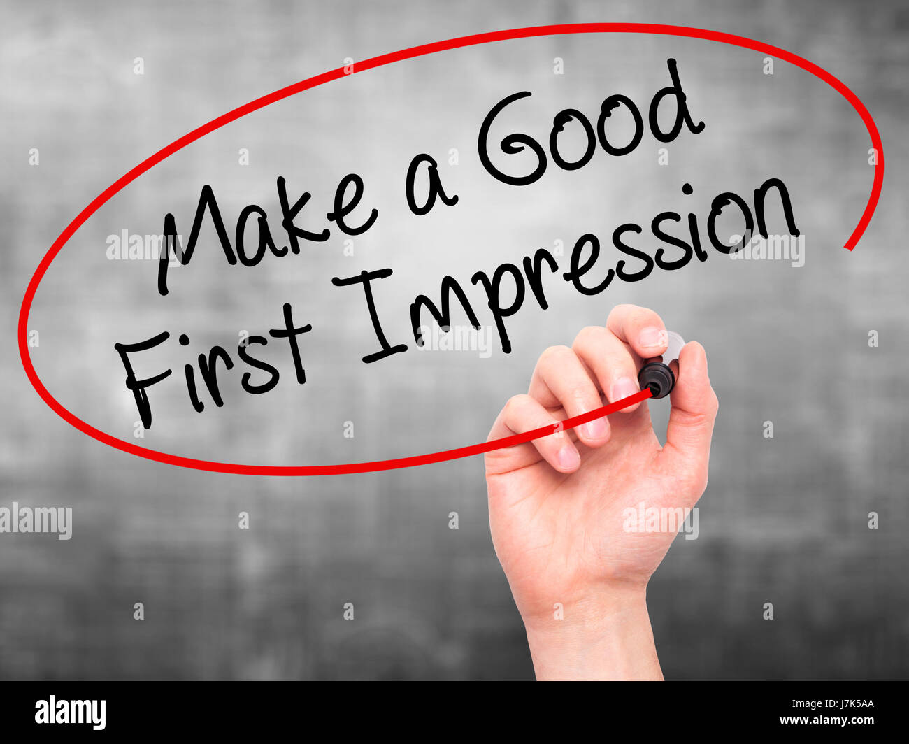 Man Hand writing Make a Good First Impression with black marker on ...