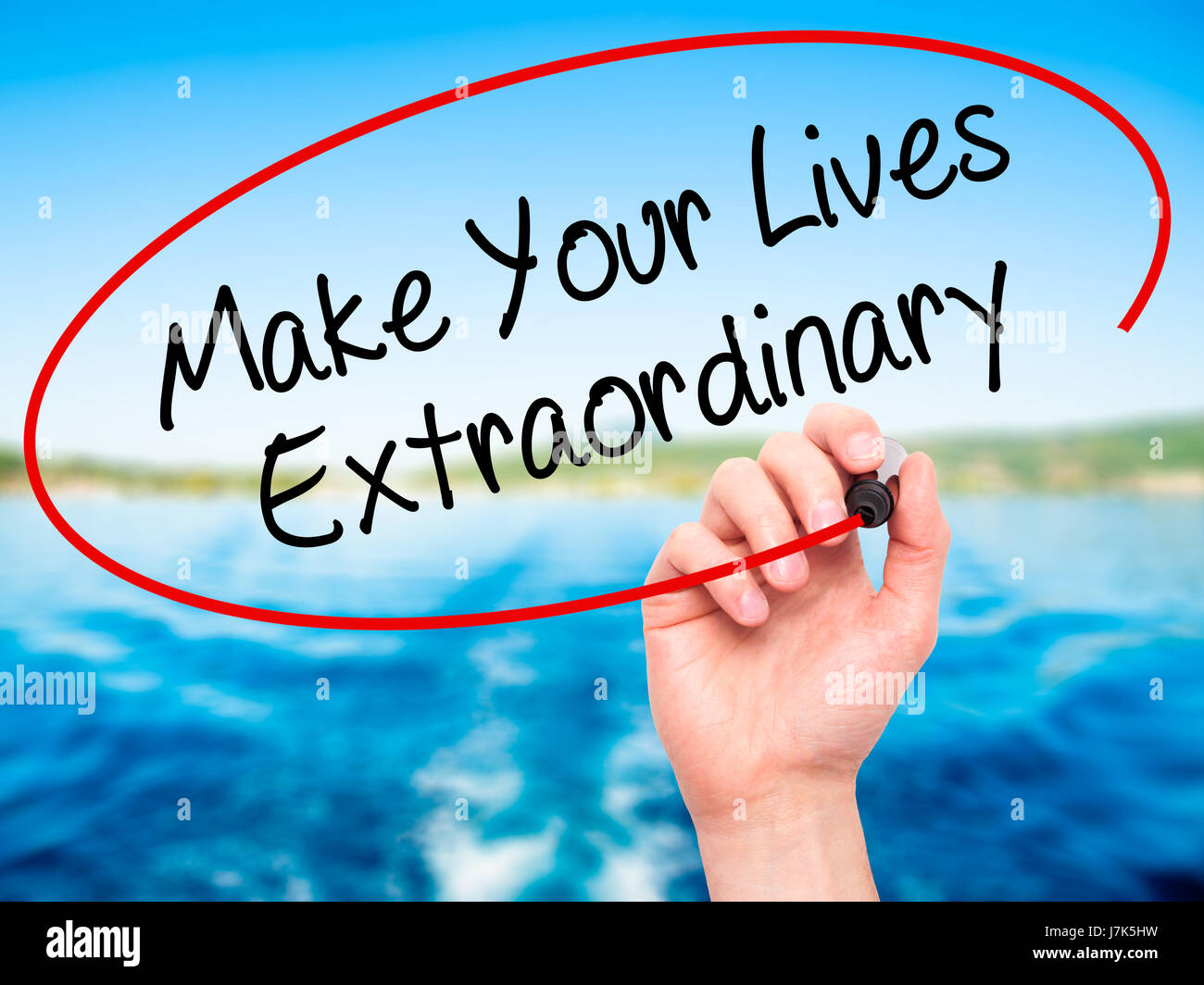 Man Hand writing Make Your Lives Extraordinary with black marker on ...
