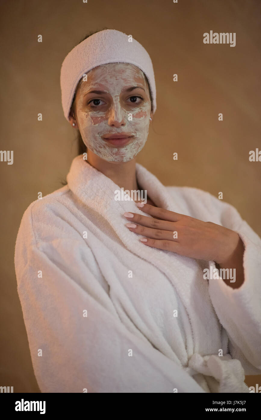 Spa Woman applying Facial Mask Beauty Treatments Close up portrait of ...