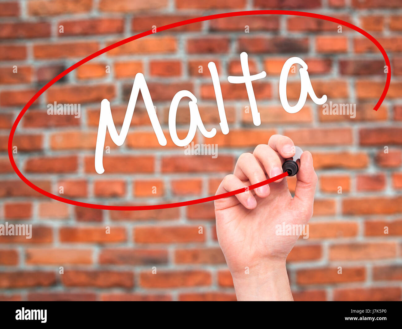 Man Hand writing Malta with black marker on visual screen. Isolated on ...