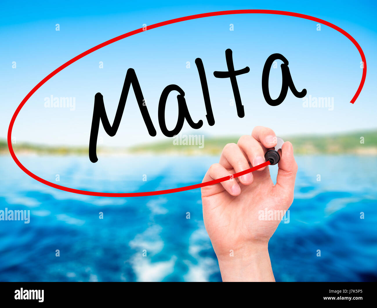 Man Hand writing Malta with black marker on visual screen. Isolated on ...