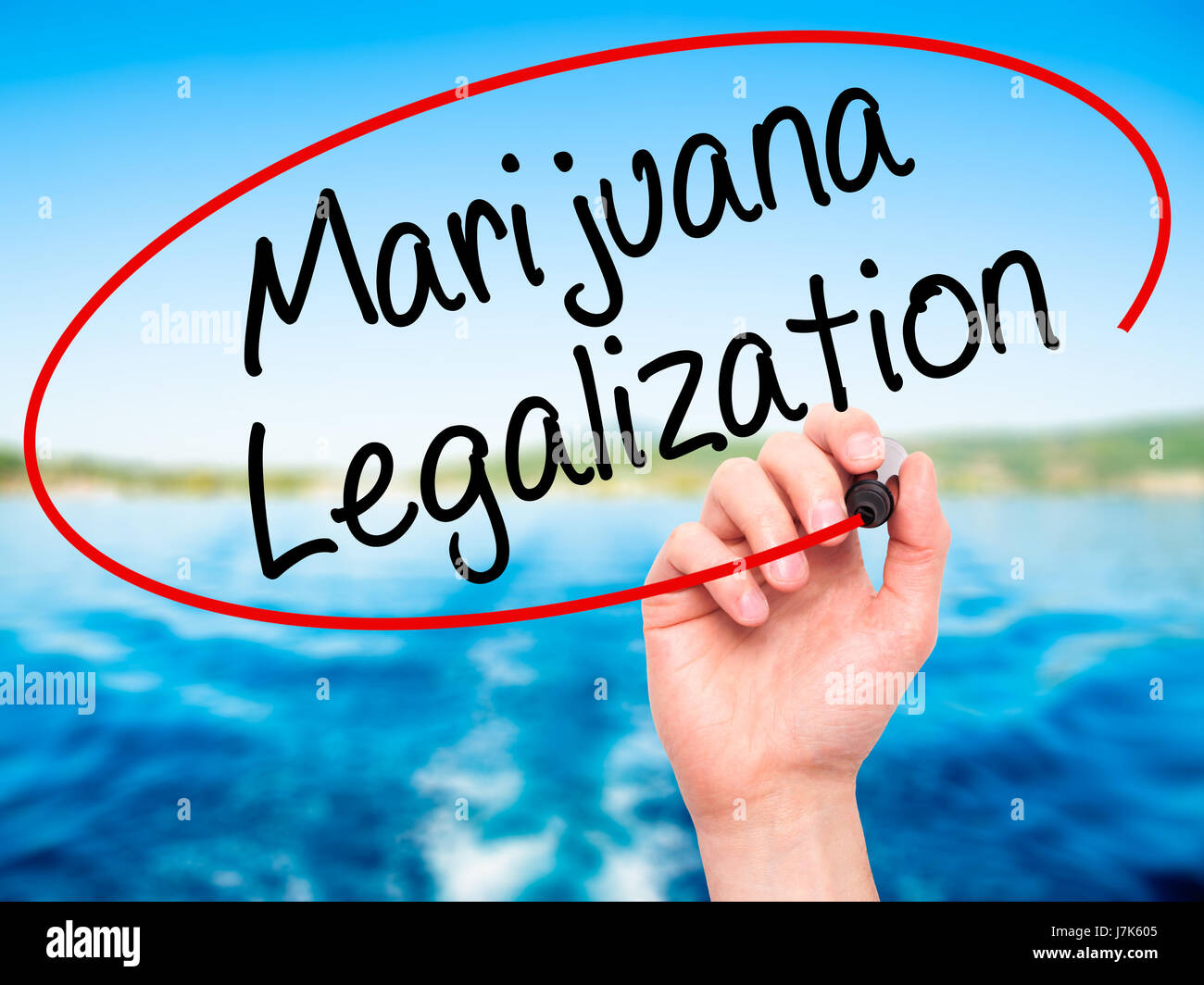 Man Hand writing Marijuana Legalization with black marker on visual ...