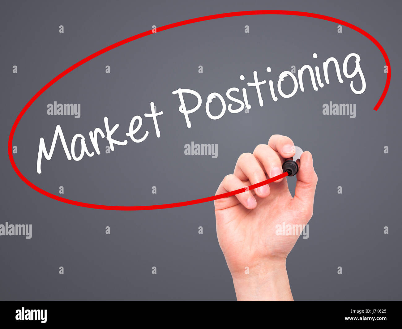 Man Hand writing Market Positioning with black marker on visual screen ...