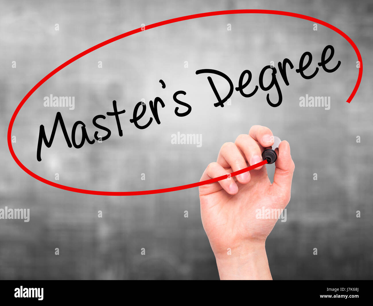 Man Hand writing Master's Degree with black marker on visual screen ...