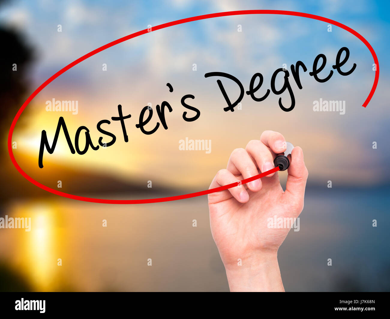 Man Hand writing Master's Degree with black marker on visual screen ...