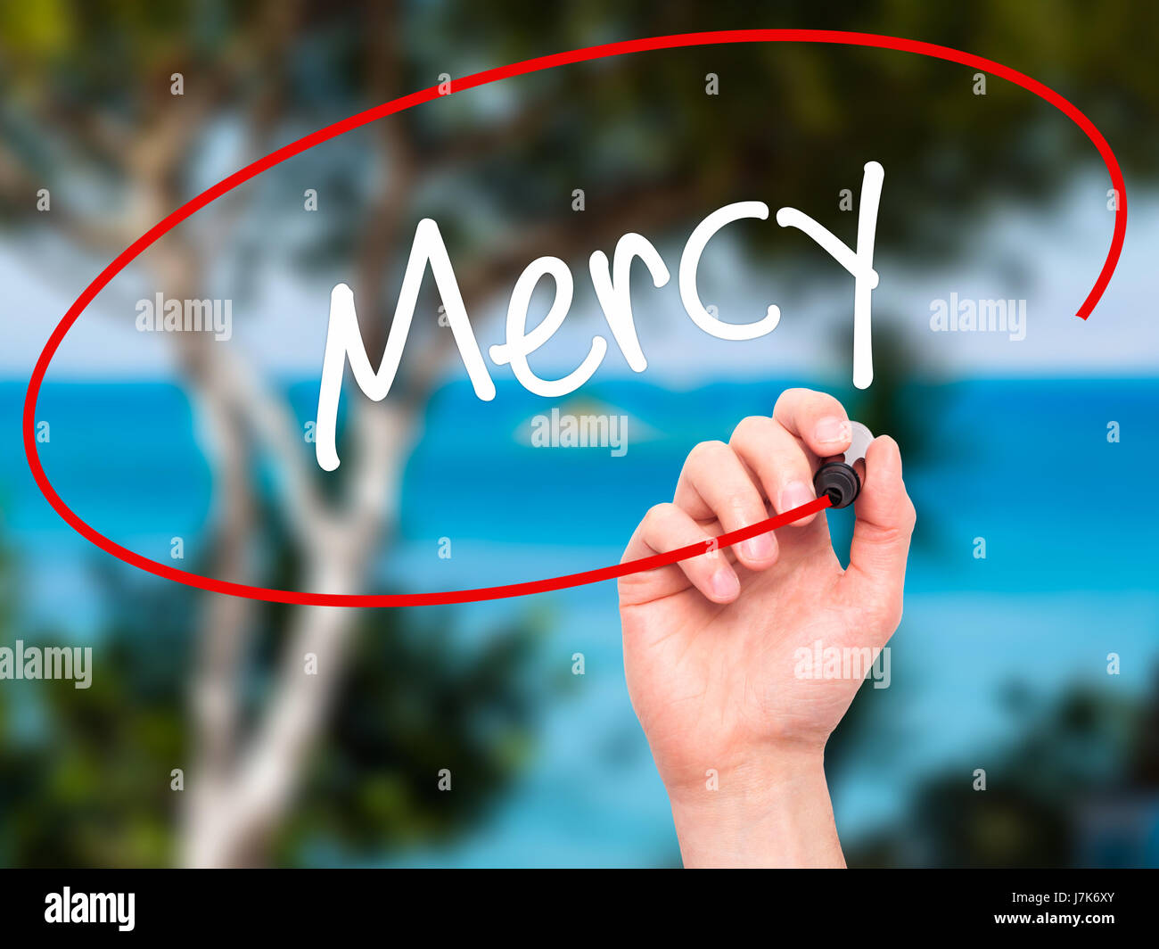 Man Hand writing Mercy with black marker on visual screen. Isolated on ...