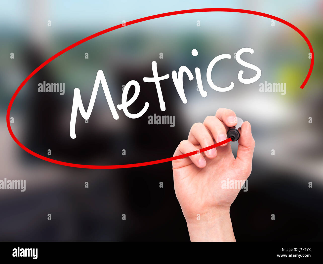Man Hand writing Metrics with black marker on visual screen. Isolated ...