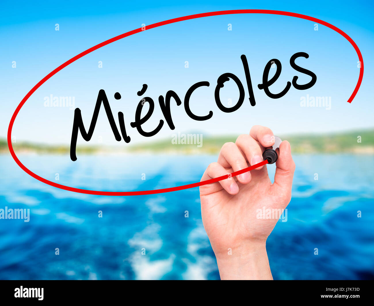 Man Hand writing MiĂ ?Ă‚Â©rcoles (Wednesday in Spanish) with black ...