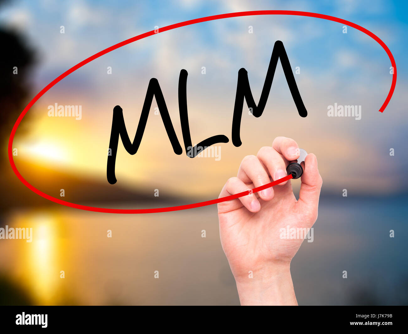 Man Hand writing MLM (Multi-Level Marketing) with black marker on ...