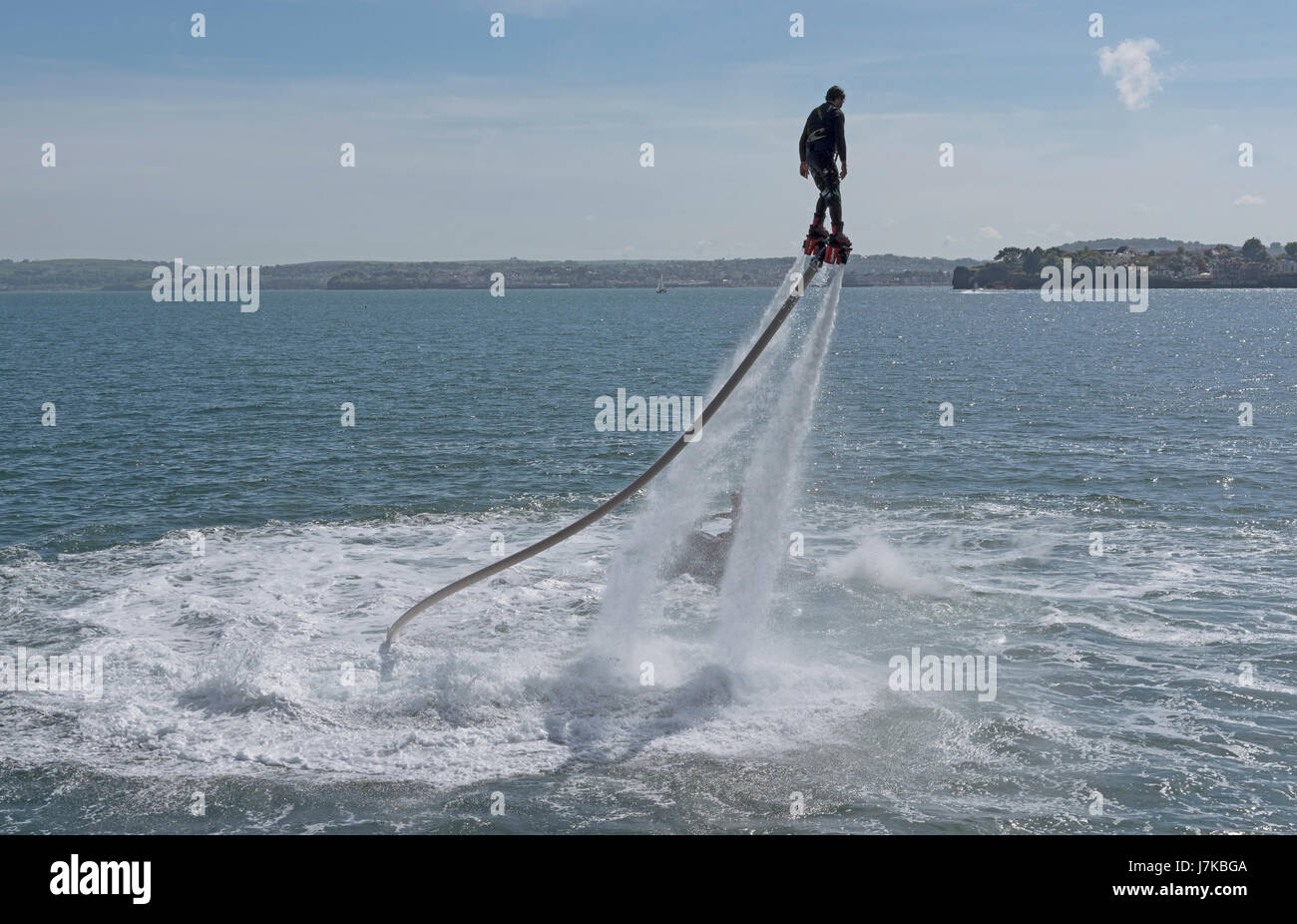 Man flyboarding on the south west coast at Torquay South Devon England ...