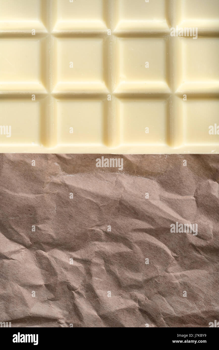 Close-up of white chocolate bar over paper wrapper background Stock ...