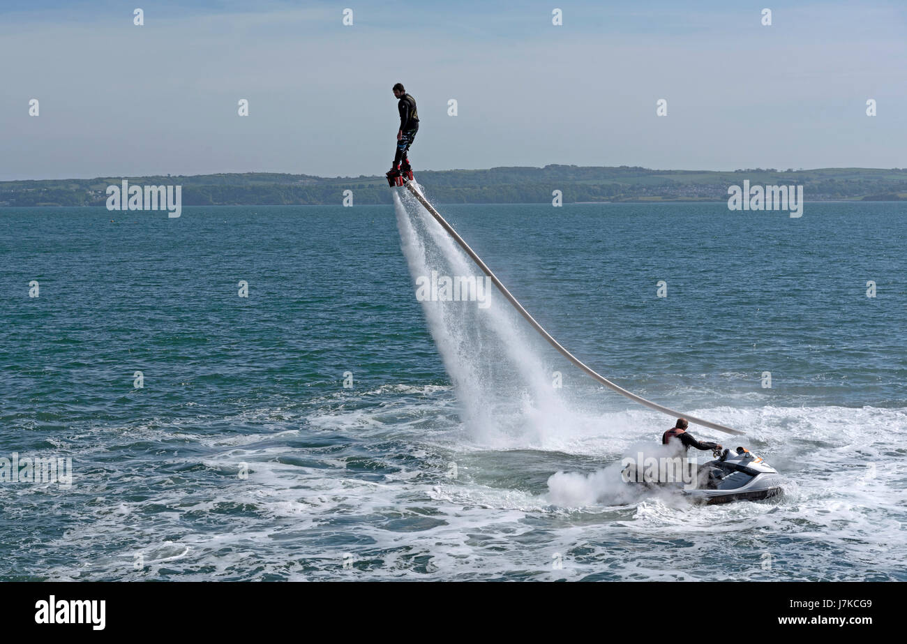 Man flyboarding on the south west coast at Torquay South Devon England ...