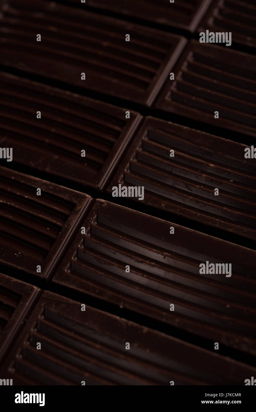 Close up of dark chocolate bar tiles pattern Stock Photo - Alamy