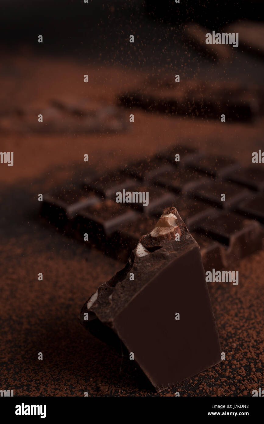 Close up of chocolate bar crashed into pieces over wooden surface Stock ...