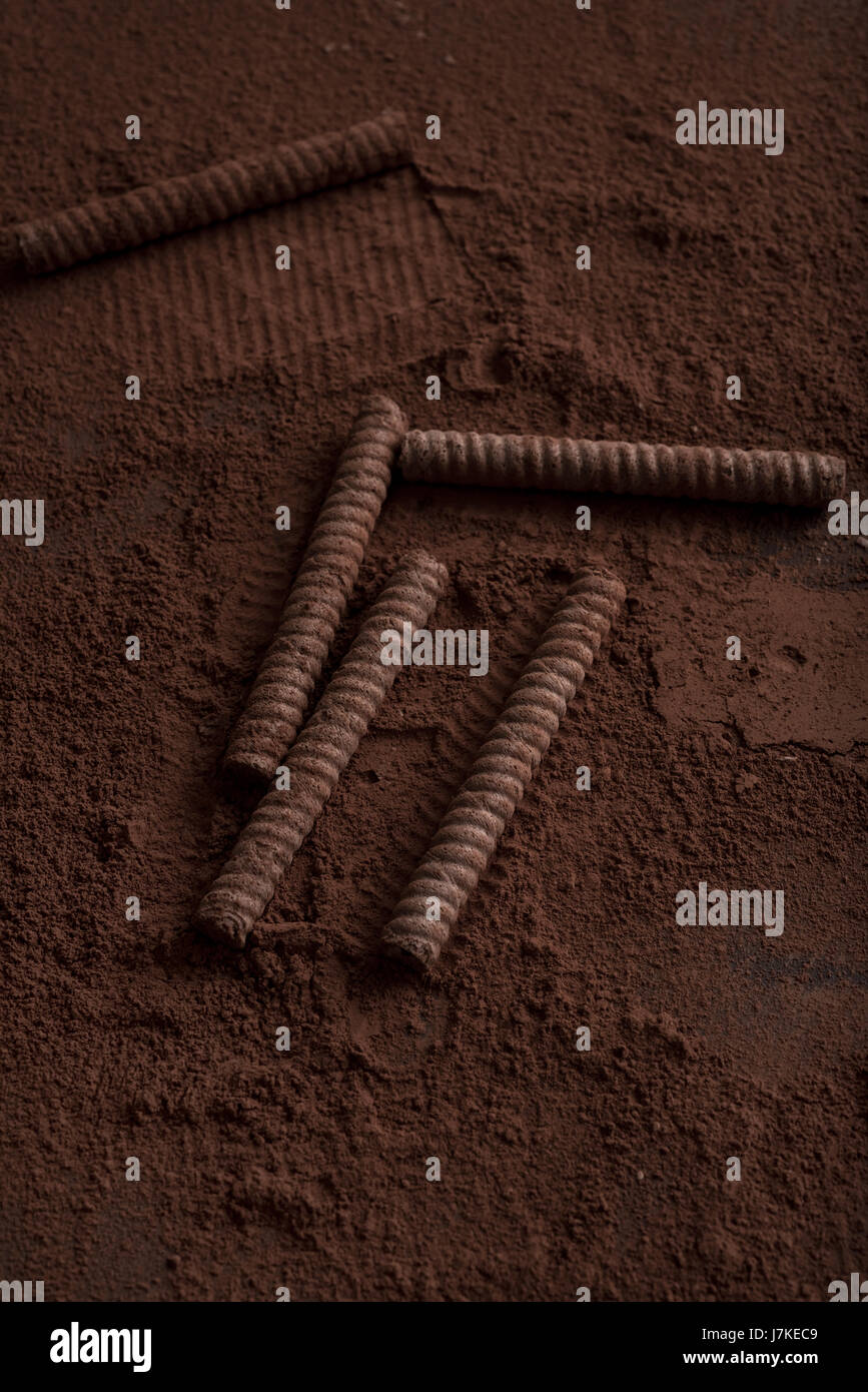 Close-up of chocolate waffle rolls covered in powder and spread all ...