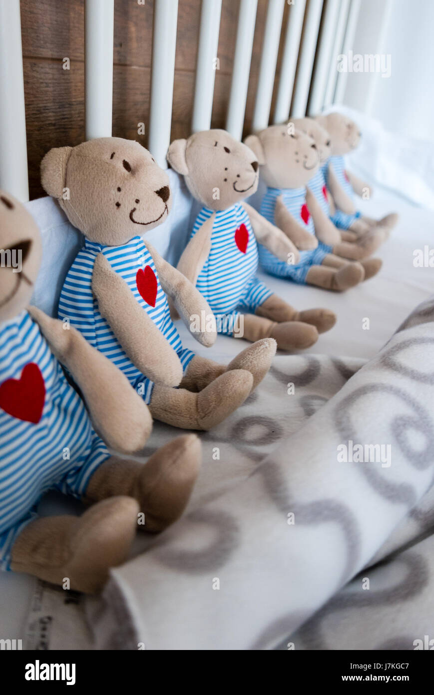 Six sweet teddy bears on baby cot Stock Photo - Alamy