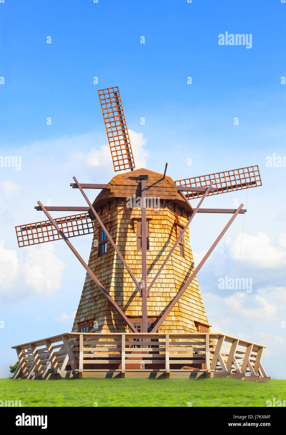 beautiful wind mills on green grass field against natural blue sky ...
